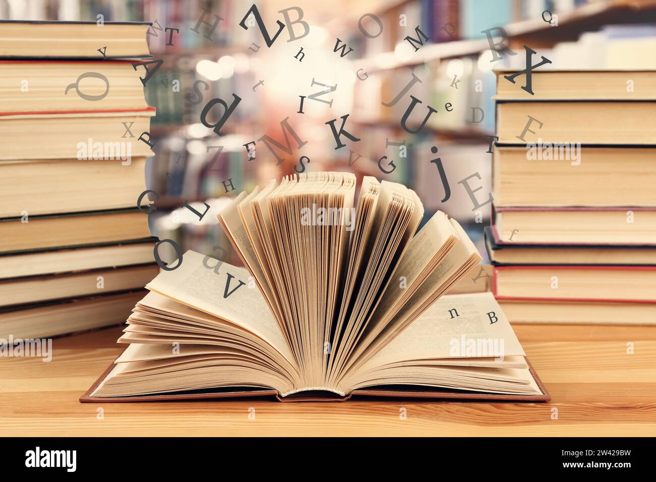 Letters flying out of an open book hi-res stock photography and images ...