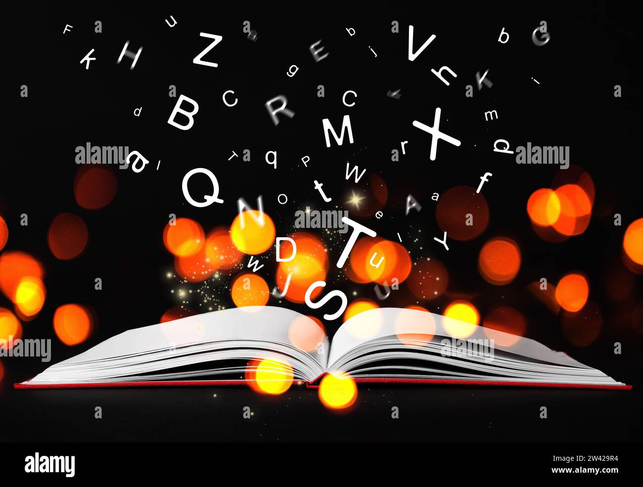 Letters flying out from open book on black background, bokeh effect ...