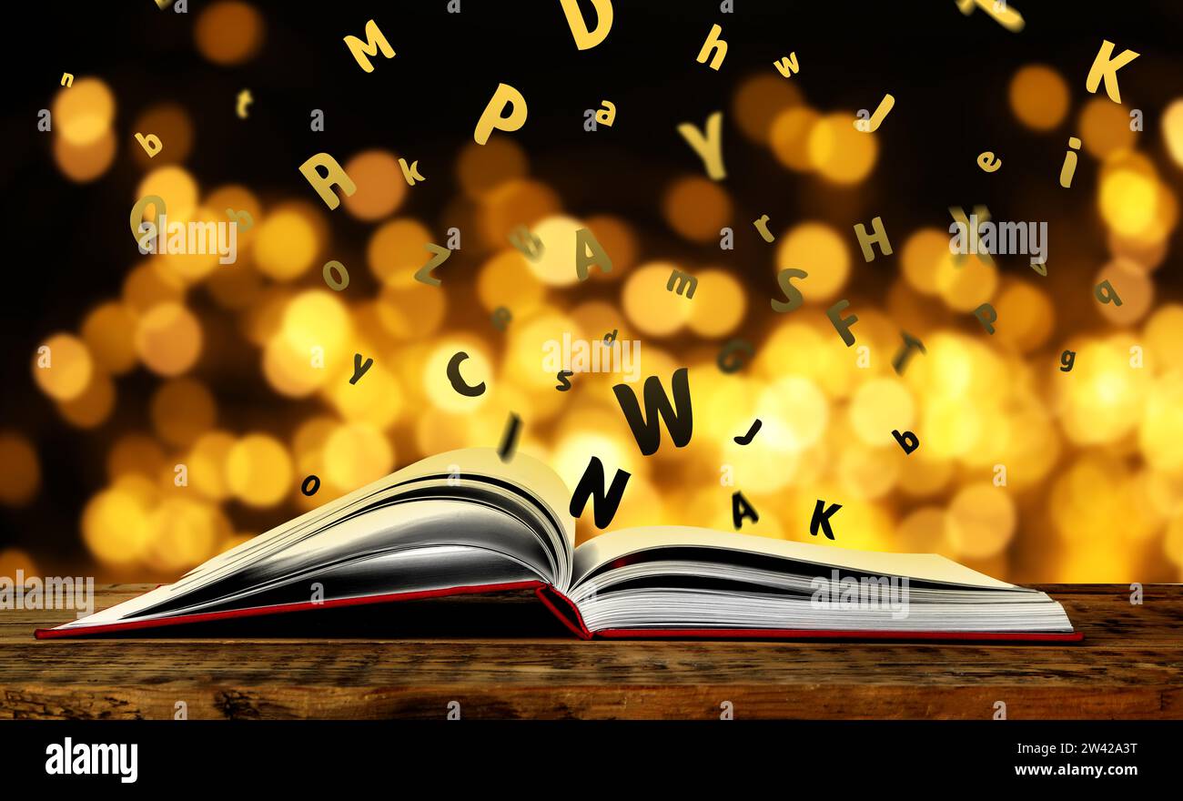 Letters flying out from open book on wooden table, bokeh effect. Banner ...