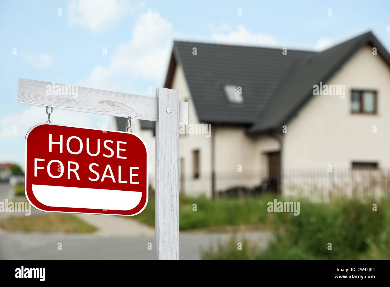 Sale sign near beautiful house outdoors. Red signboard with words Stock ...