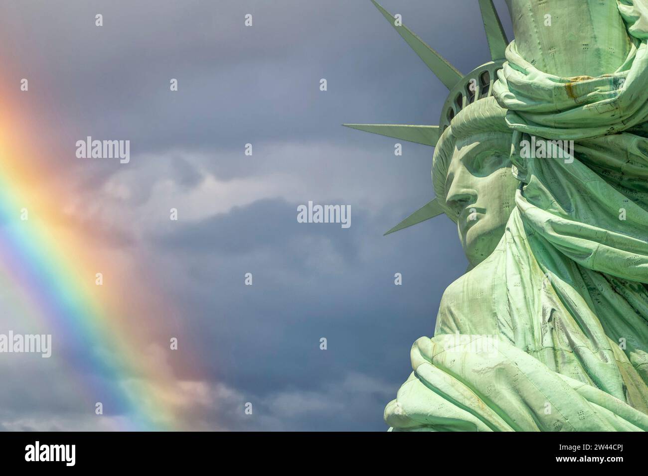 The statue of liberty on a rainbow blue and clouds sky background Stock ...