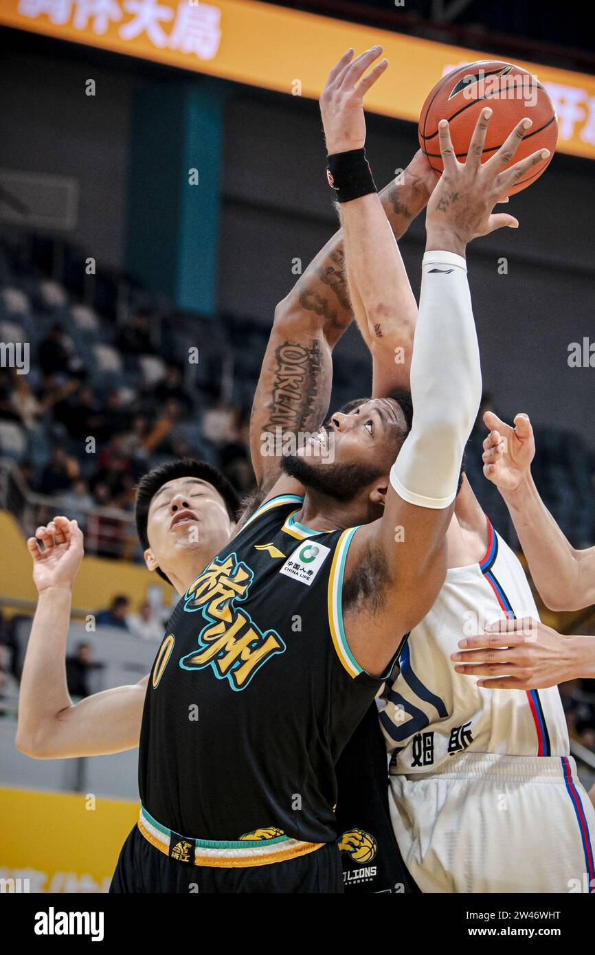 Hangzhou, China's Zhejiang Province. 21st Dec, 2023. Cameron Oliver (front) of Zhejiang Lions ...