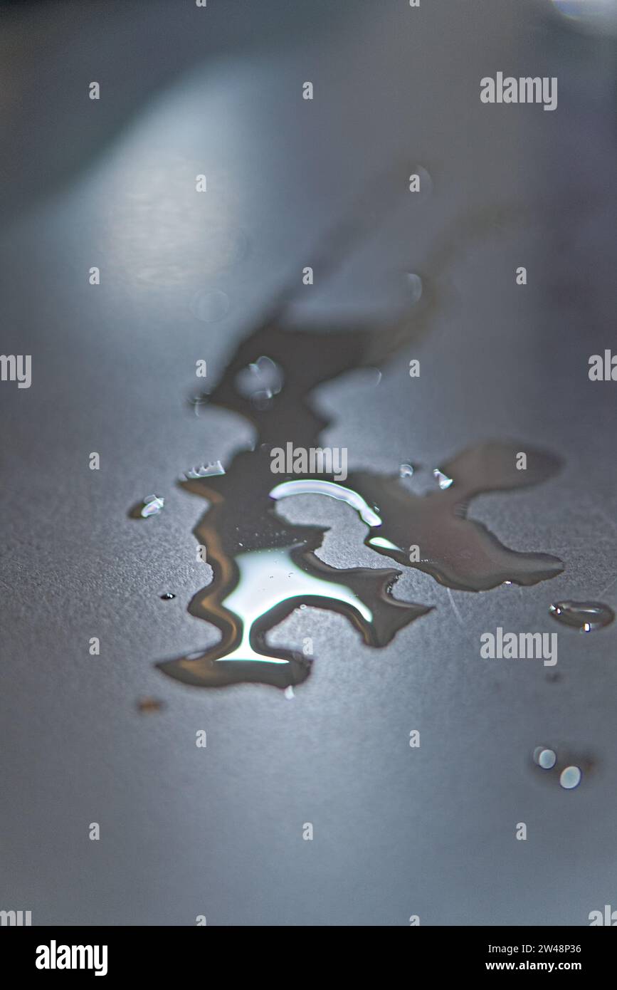 picture of water spilled over a black table cover Stock Photo - Alamy