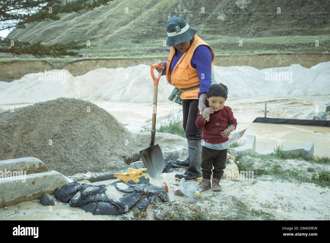 Worker with her child in a kaolin mine, Pachacayo, Peru, South America ...