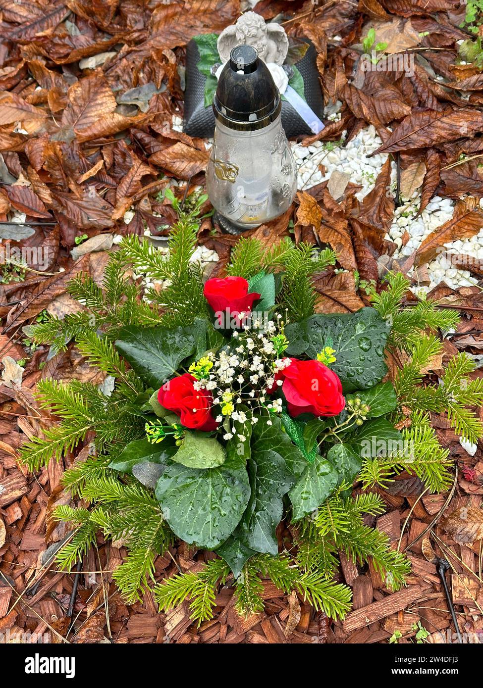 Wreath and lantern on a tombstone in the public cemetery Stock Photo - Alamy