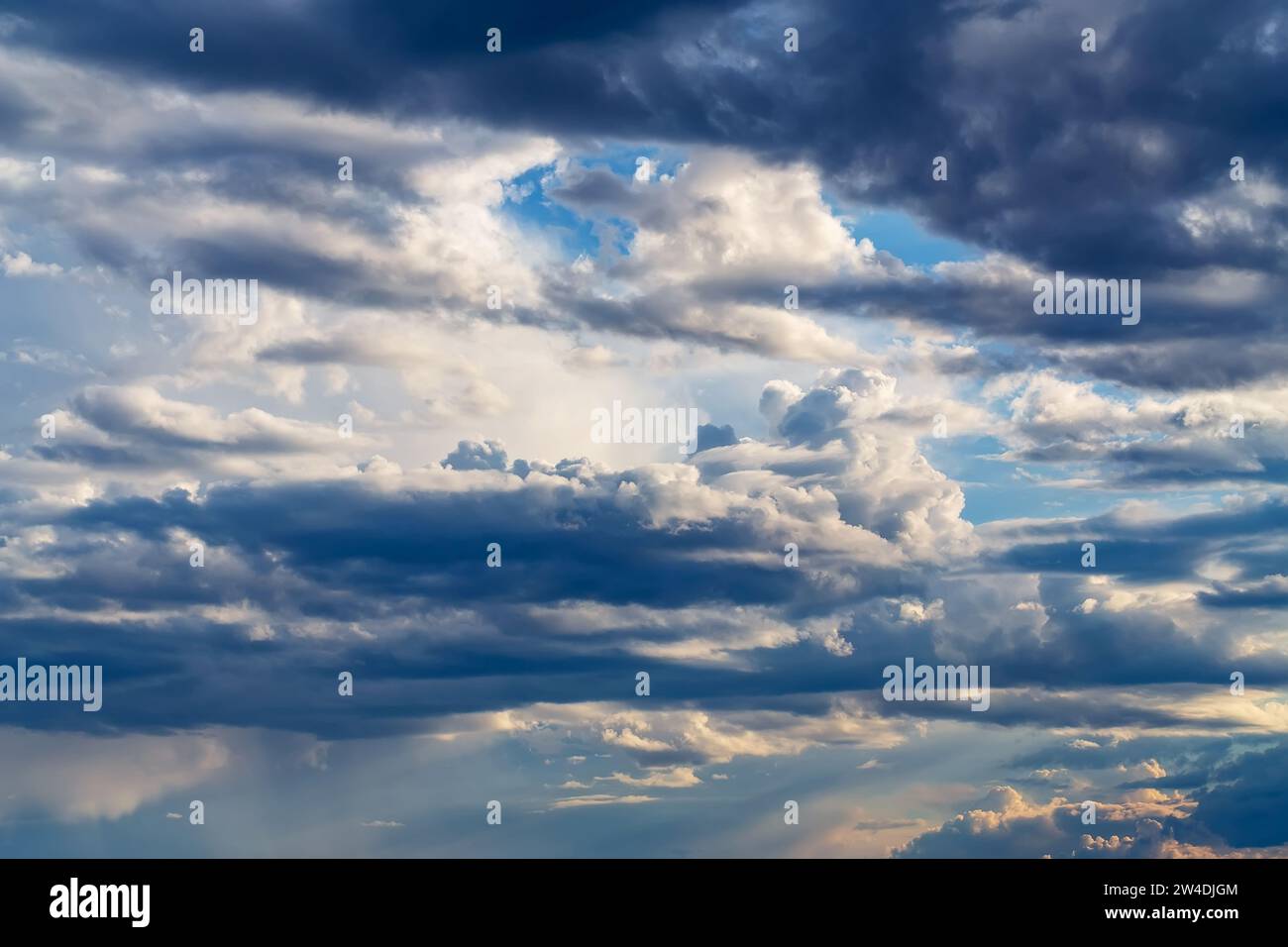 Natural cloudy background with white and dark rainy clouds before or ...