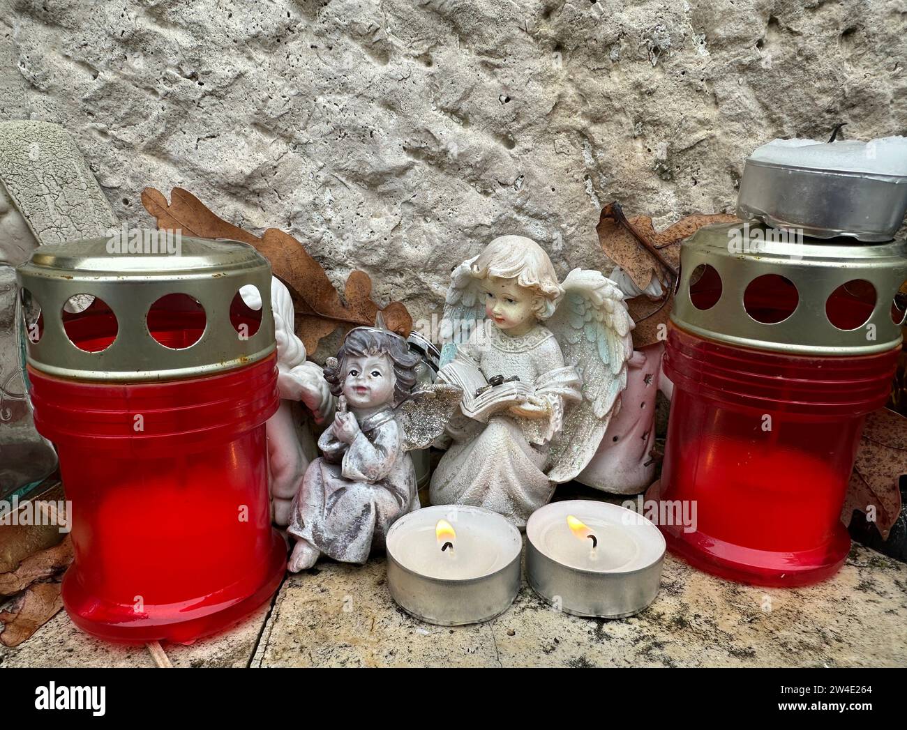 Lanterns and angel figurines on a tombstone in the public cemetery Stock Photo - Alamy