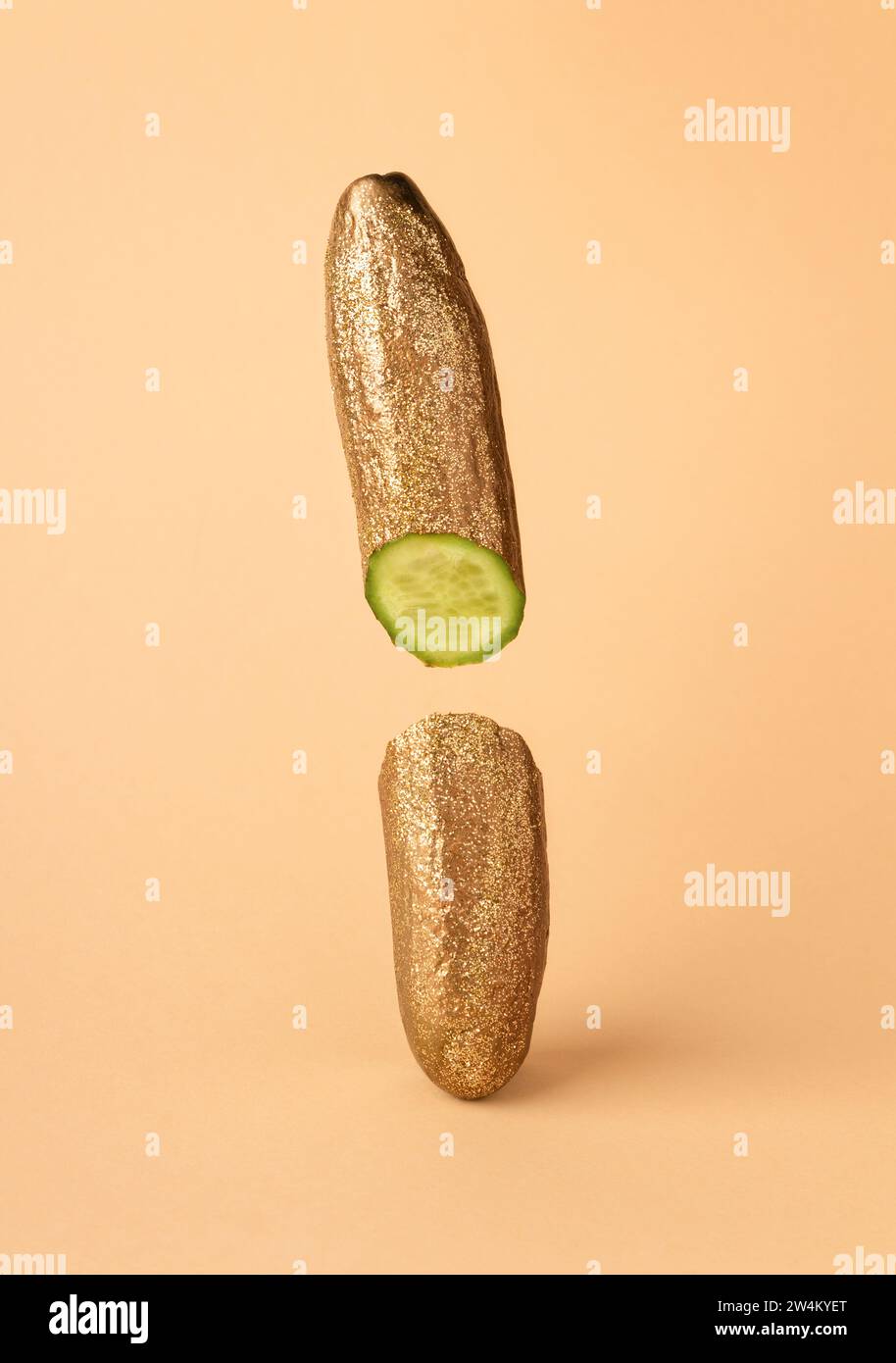 Golden cucumber covered in glitter. Creative food concept Stock Photo ...