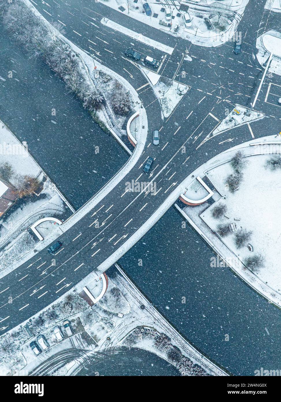 Aerial bird's eye view of a snow-covered intersection with various ...