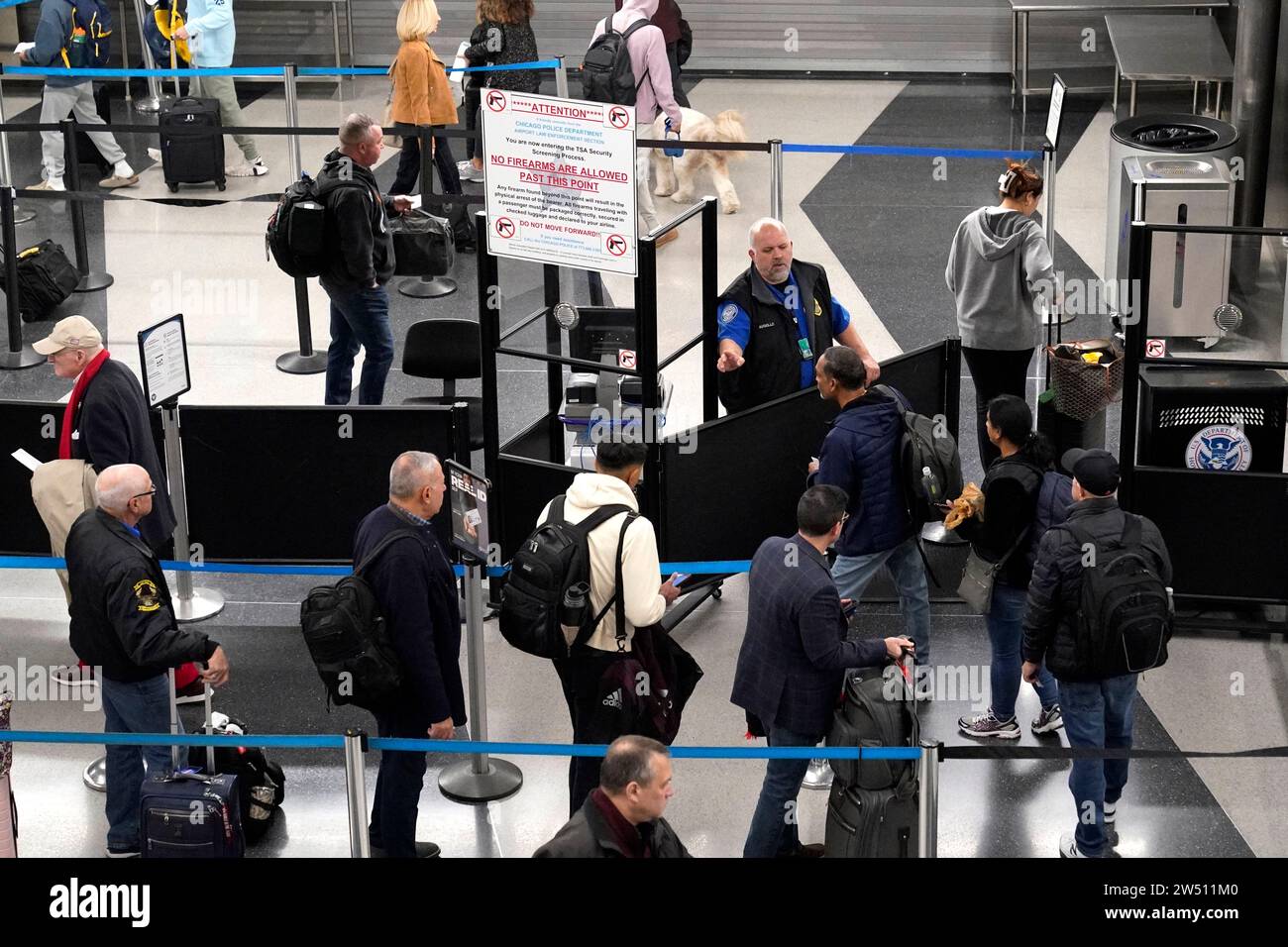 Travelers line up at a security checkpoint area in Terminal 3 at the O ...