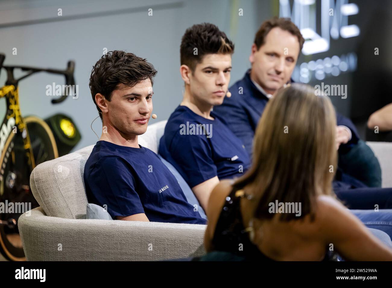 AMSTERDAM - 21/12/2023, Olav Kooij, Wout van Aert and sports director ...