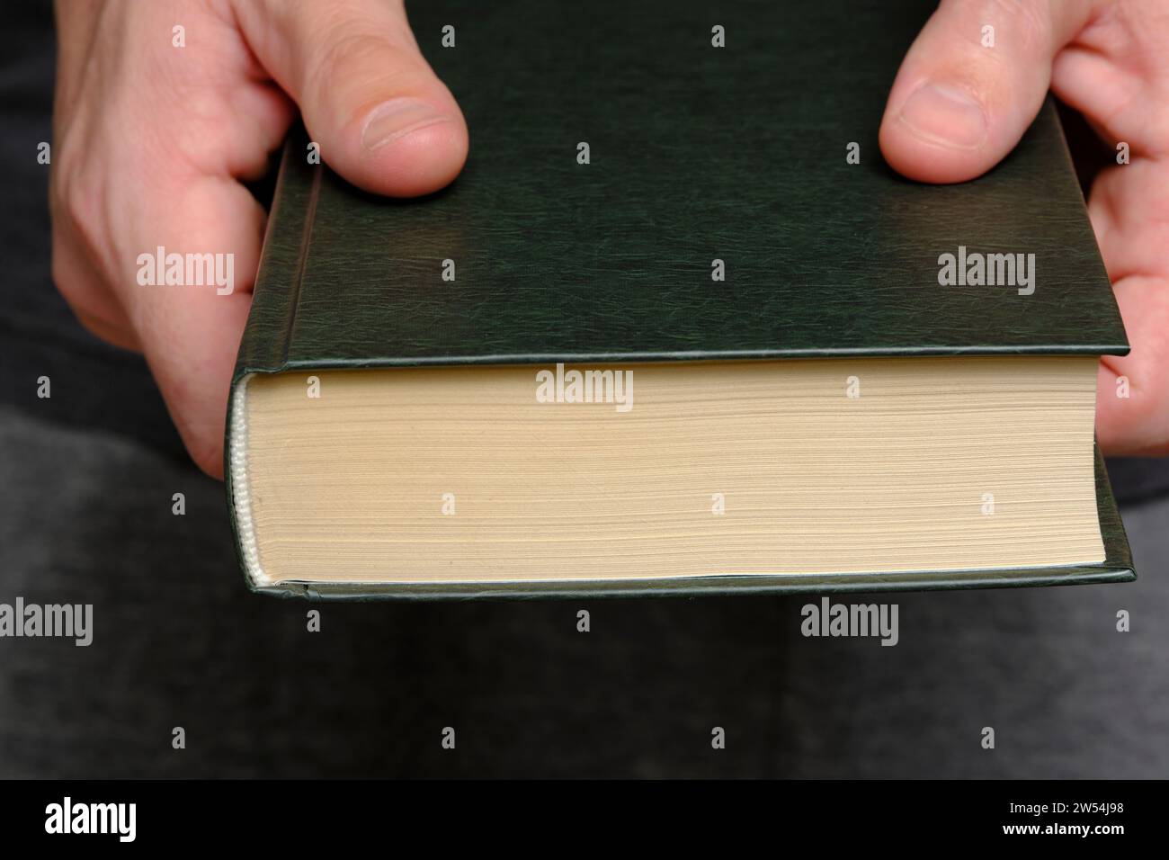 Book in hand gray background. International book giving day Stock Photo ...