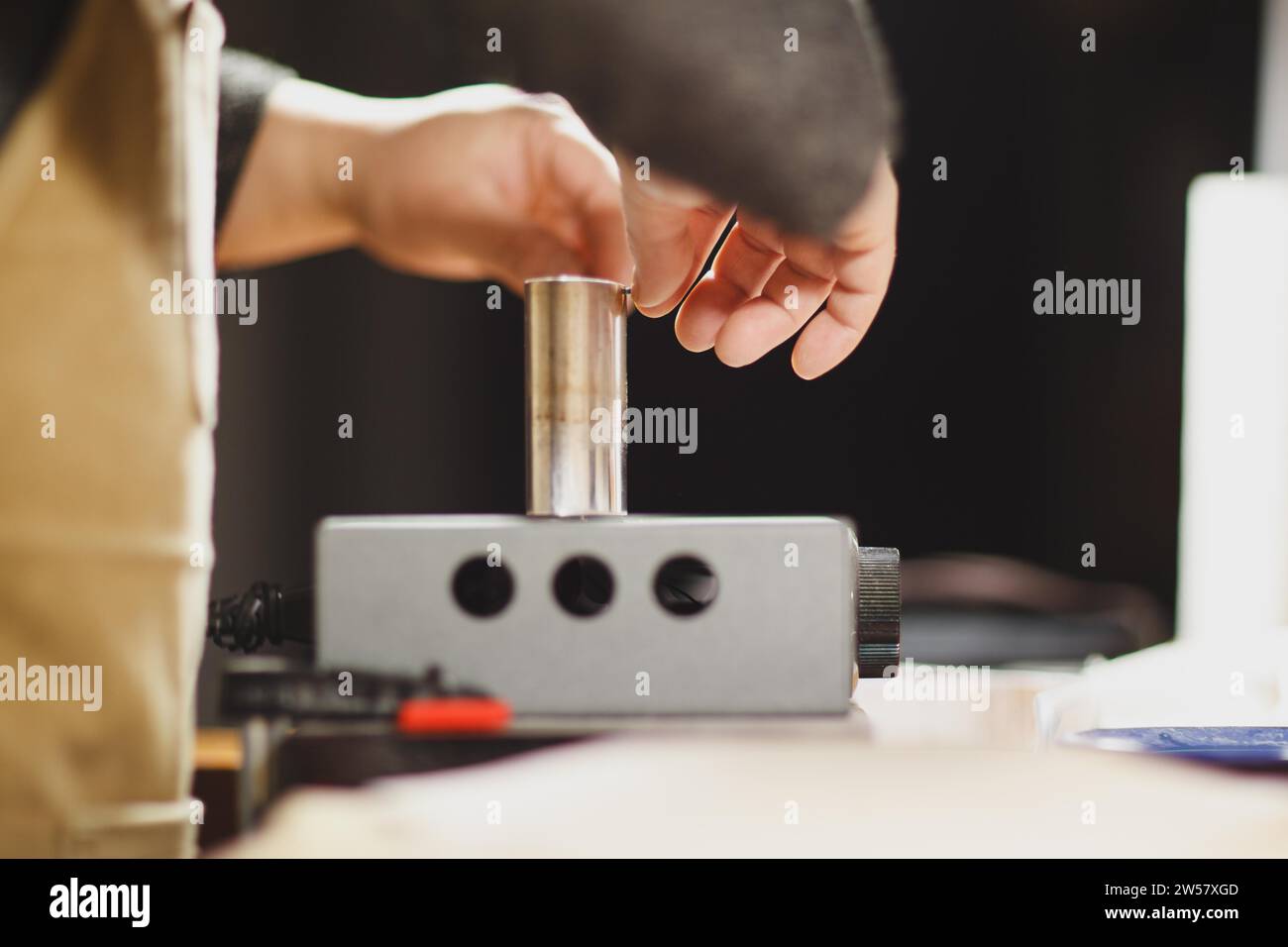 Unrecognizable luthier lute maker artisan both hands performing bend ...