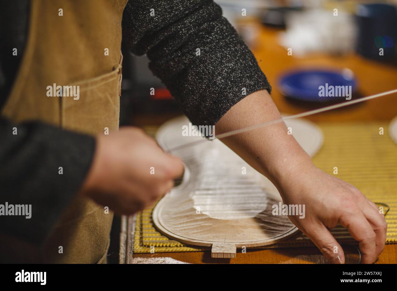Unrecognizable luthier lute maker artisan both hands performing bend ...