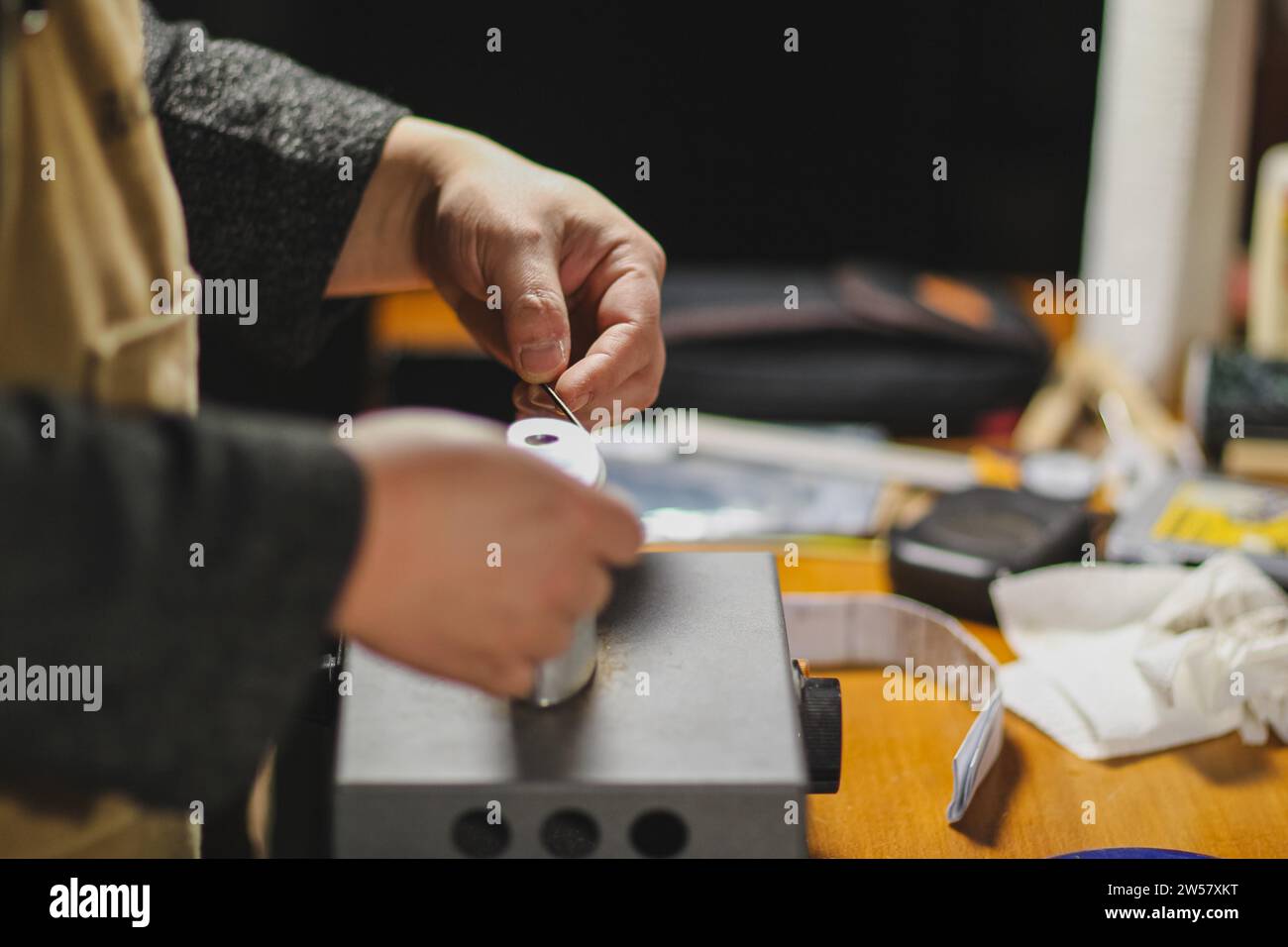 Unrecognizable luthier lute maker artisan both hands performing bend ...