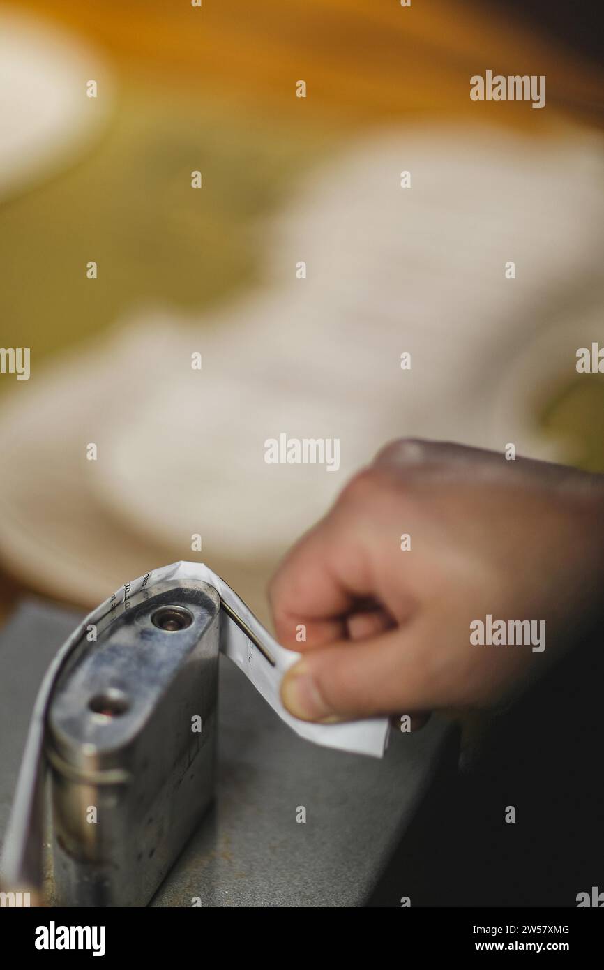 Unrecognizable luthier lute maker artisan both hands performing bend ...