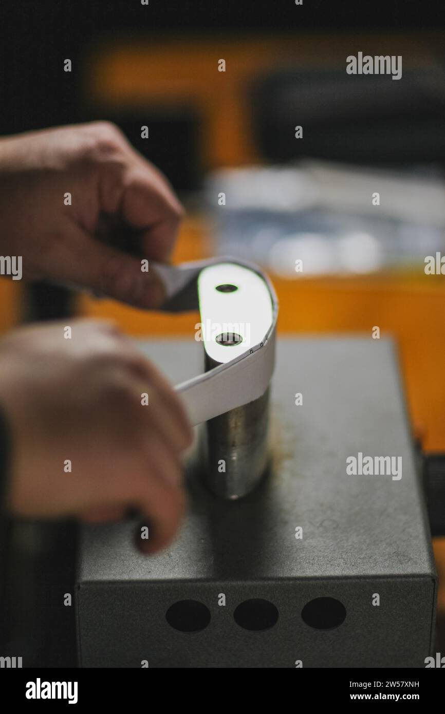 Unrecognizable luthier lute maker artisan both hands performing bend ...