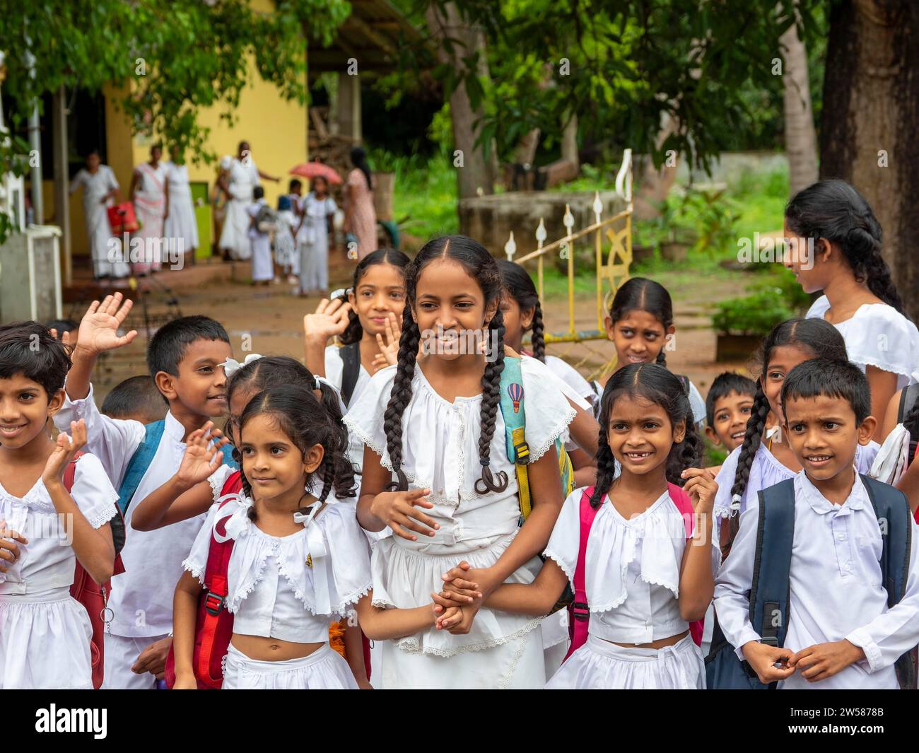 Group of school children, girls and boys in white school clothes ...