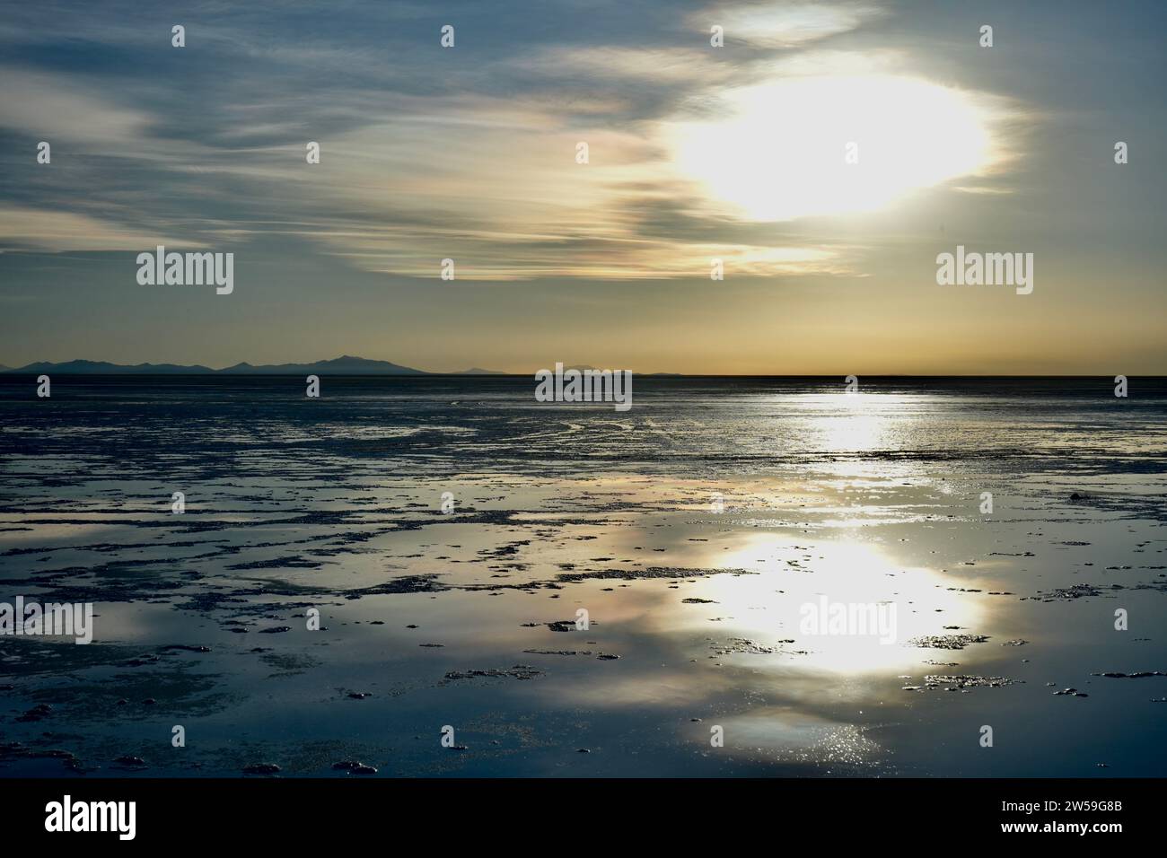 Sun Setting over the Uyuni Salt Flat, Bolivia, reflected in the saline ...