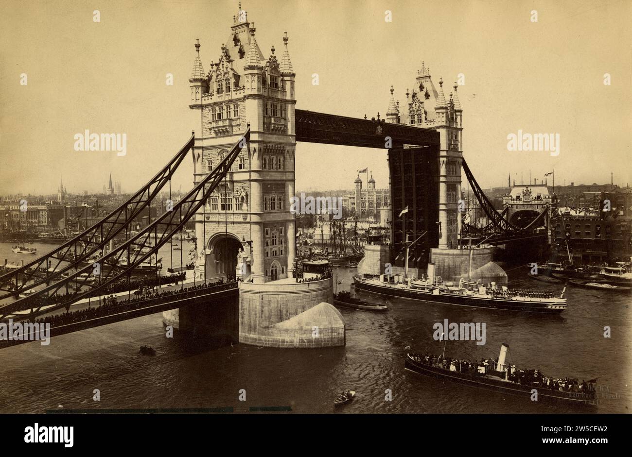Albumen print of Tower Bridge open with a ship passing through, the ...