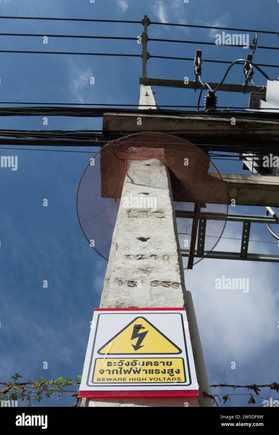 beware high voltage sign, written in thai and english, with warning ...