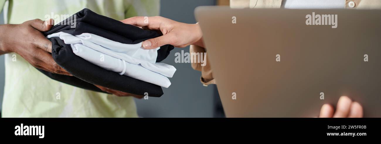 partial view of multiethnic fashion designers with laptop and new ...