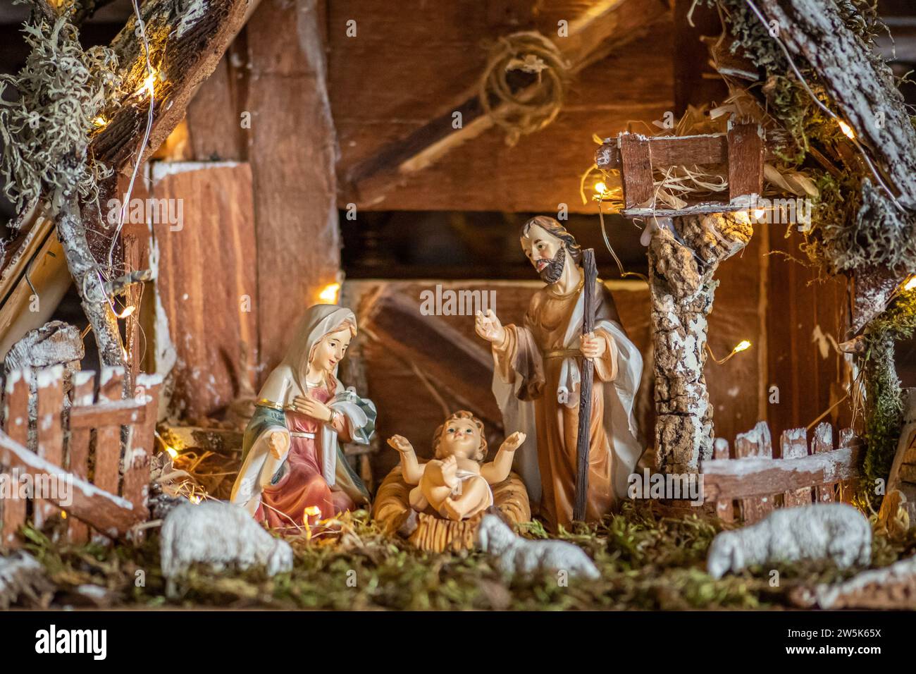 Beautiful Christmas nativity scene with holy family in a handmade wooden old stable, Italian ...