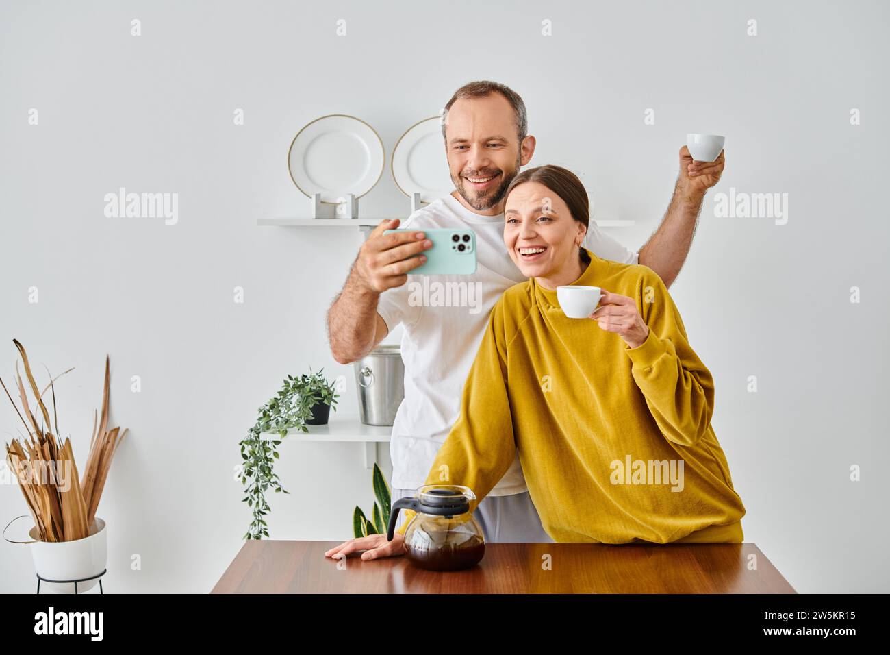 excited child-free couple talking self-portrait on smartphone during ...