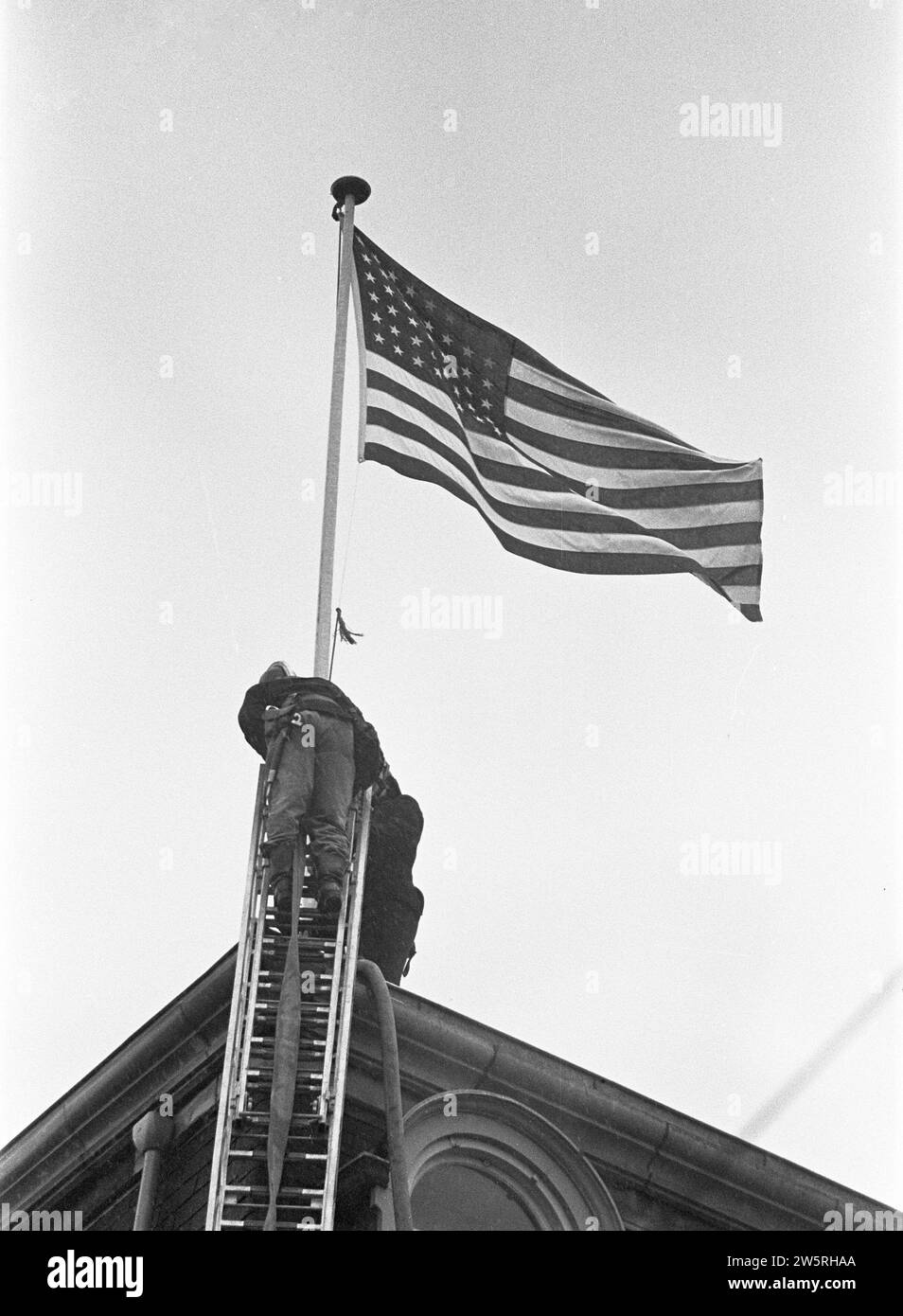 Fire in Victoria Hotel in Amsterdam, firefighters atop a ladder, next ...