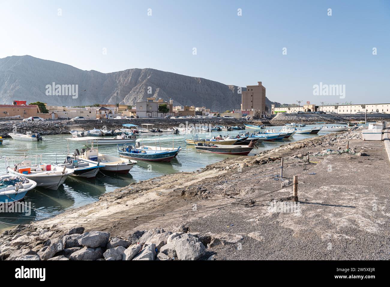 Boats moored at the end of the eastern Sea Canal with Khasab town ...