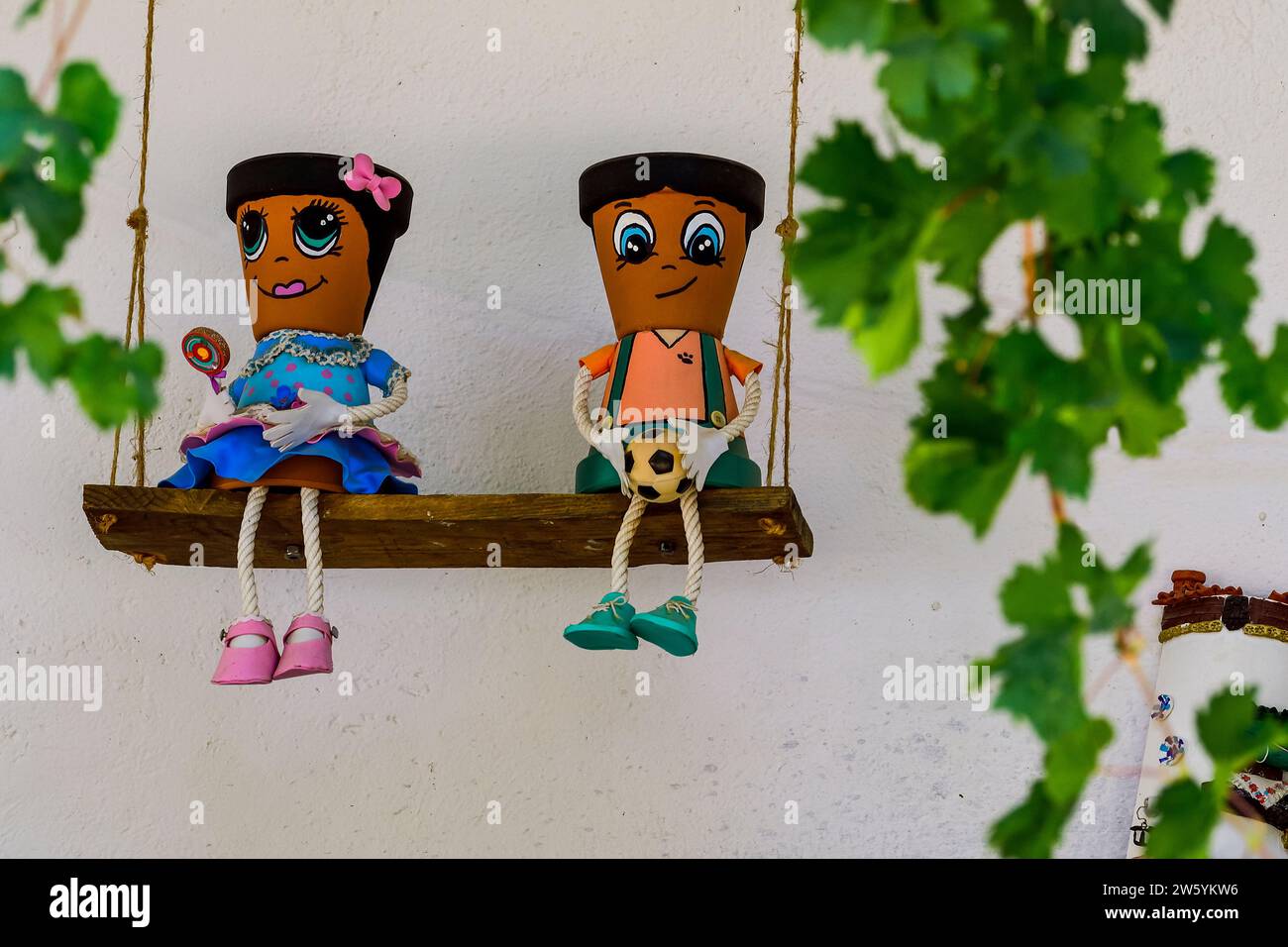 Handicraft human figures with two pots Stock Photo - Alamy