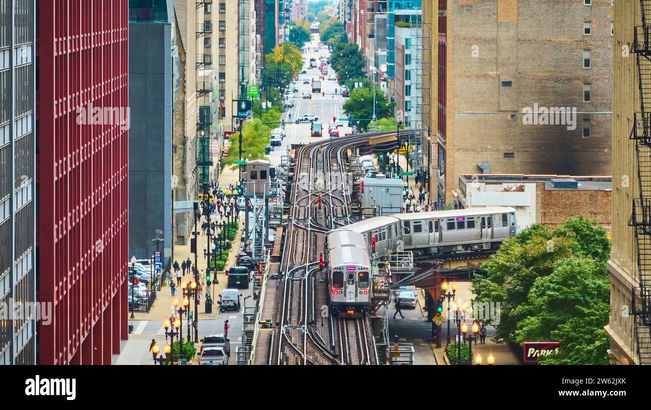 Train on tracks in Chicago aerial of big, inner city transit, travel and tourism with buildings ...