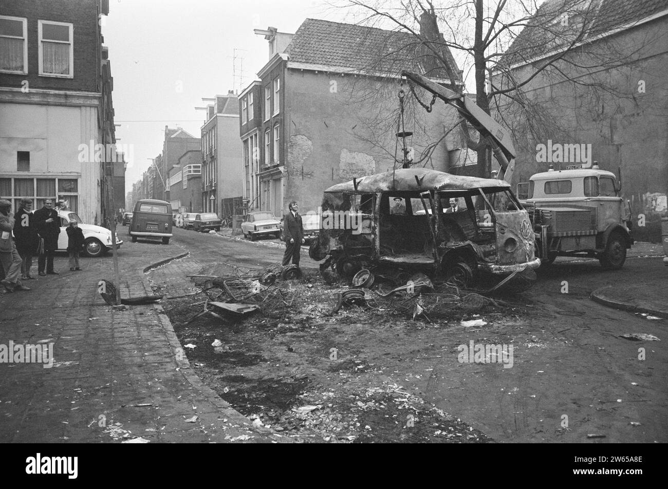 Burned out VW van is towed away by a tow truck in Amsterdam ca. January ...