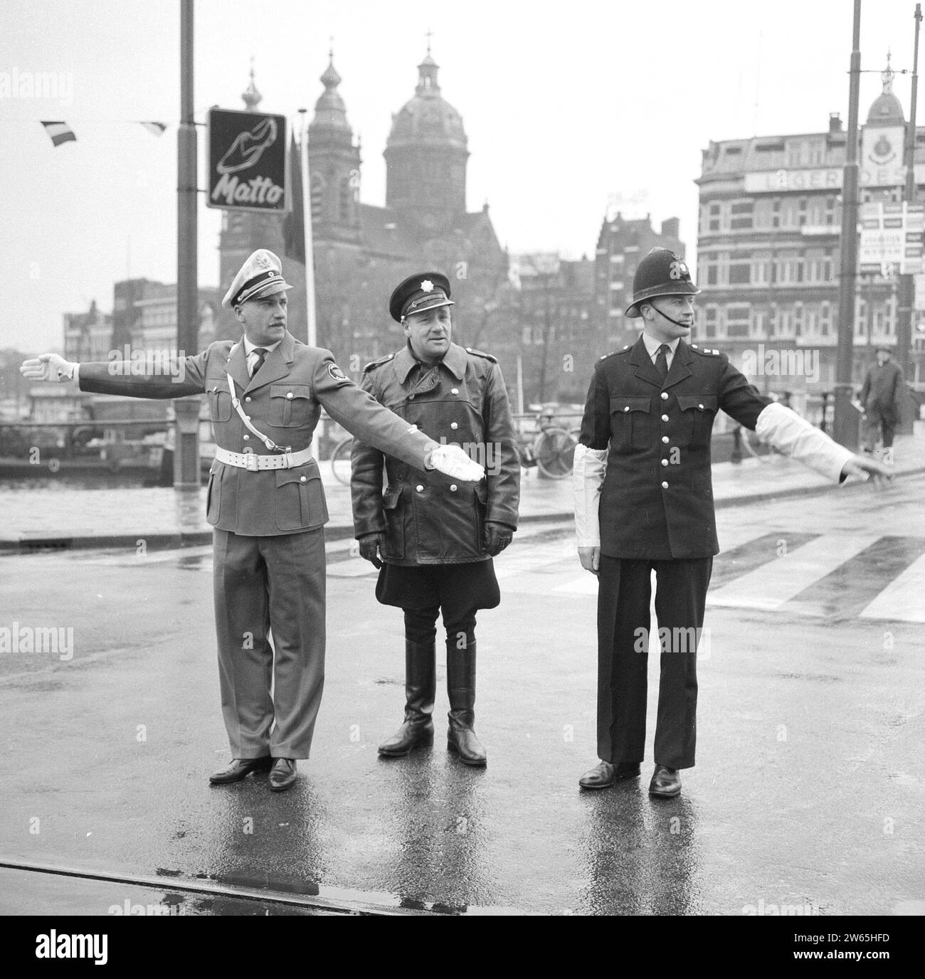 (original caption) West German agent arranges traffic Damrak, Prins ...