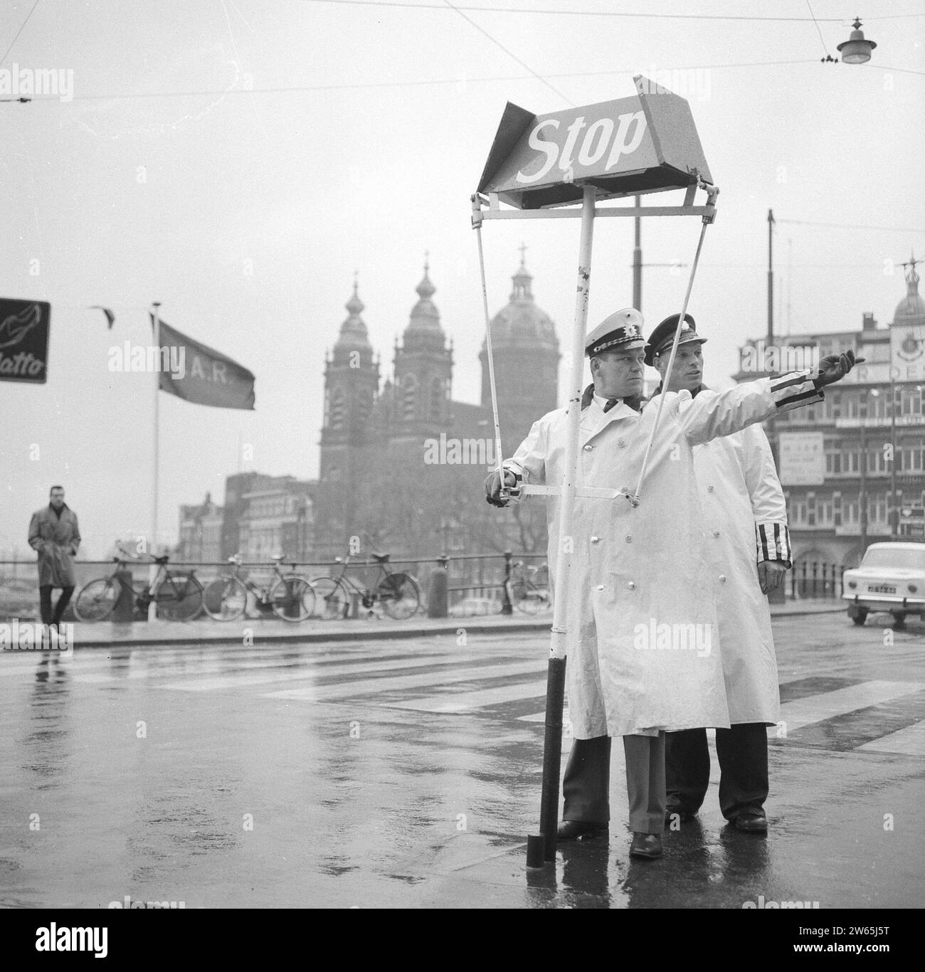 (original caption) West German agent arranges traffic Damrak, Prins ...