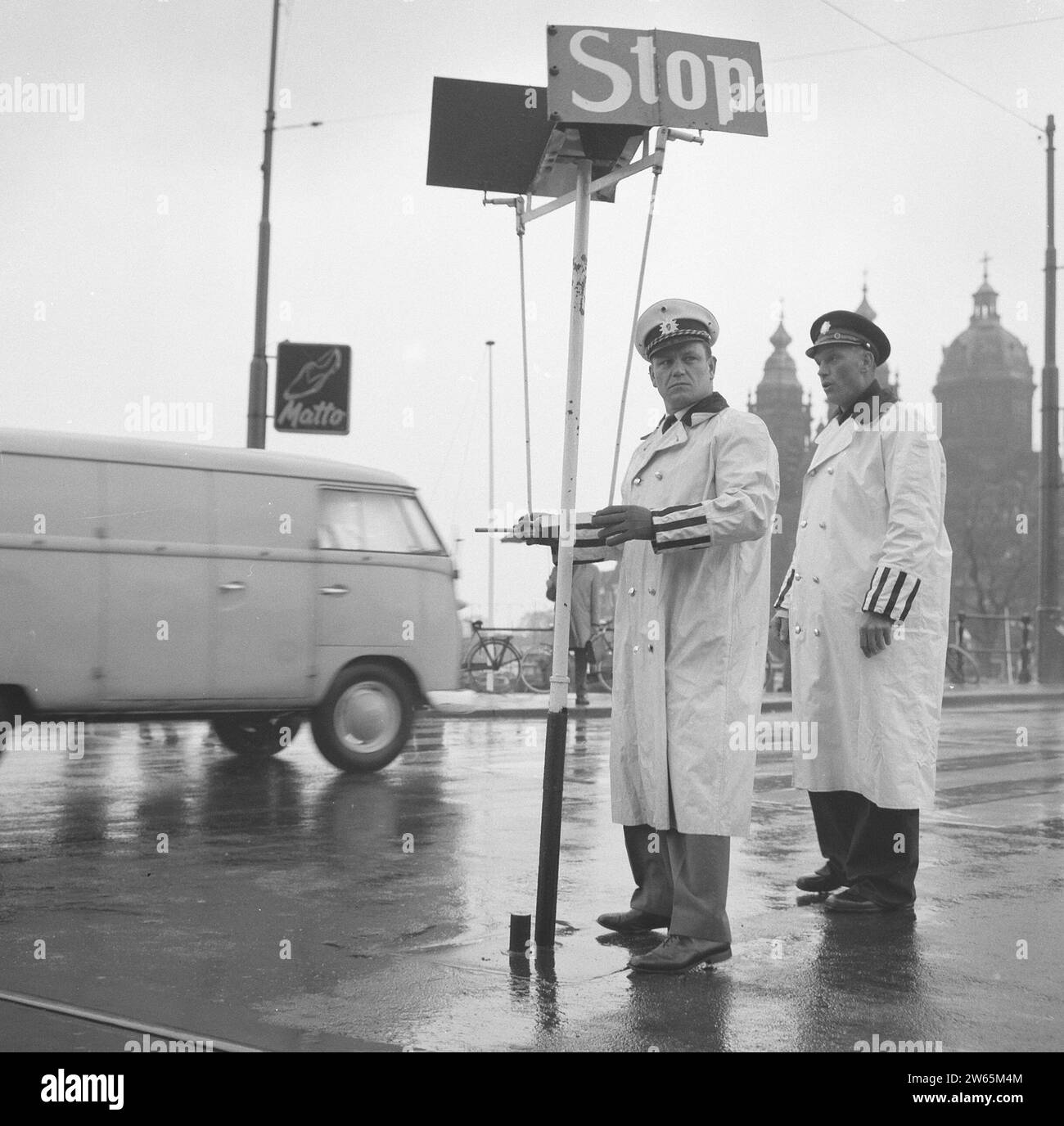 (original caption) West German agent arranges traffic Damrak, Prins ...