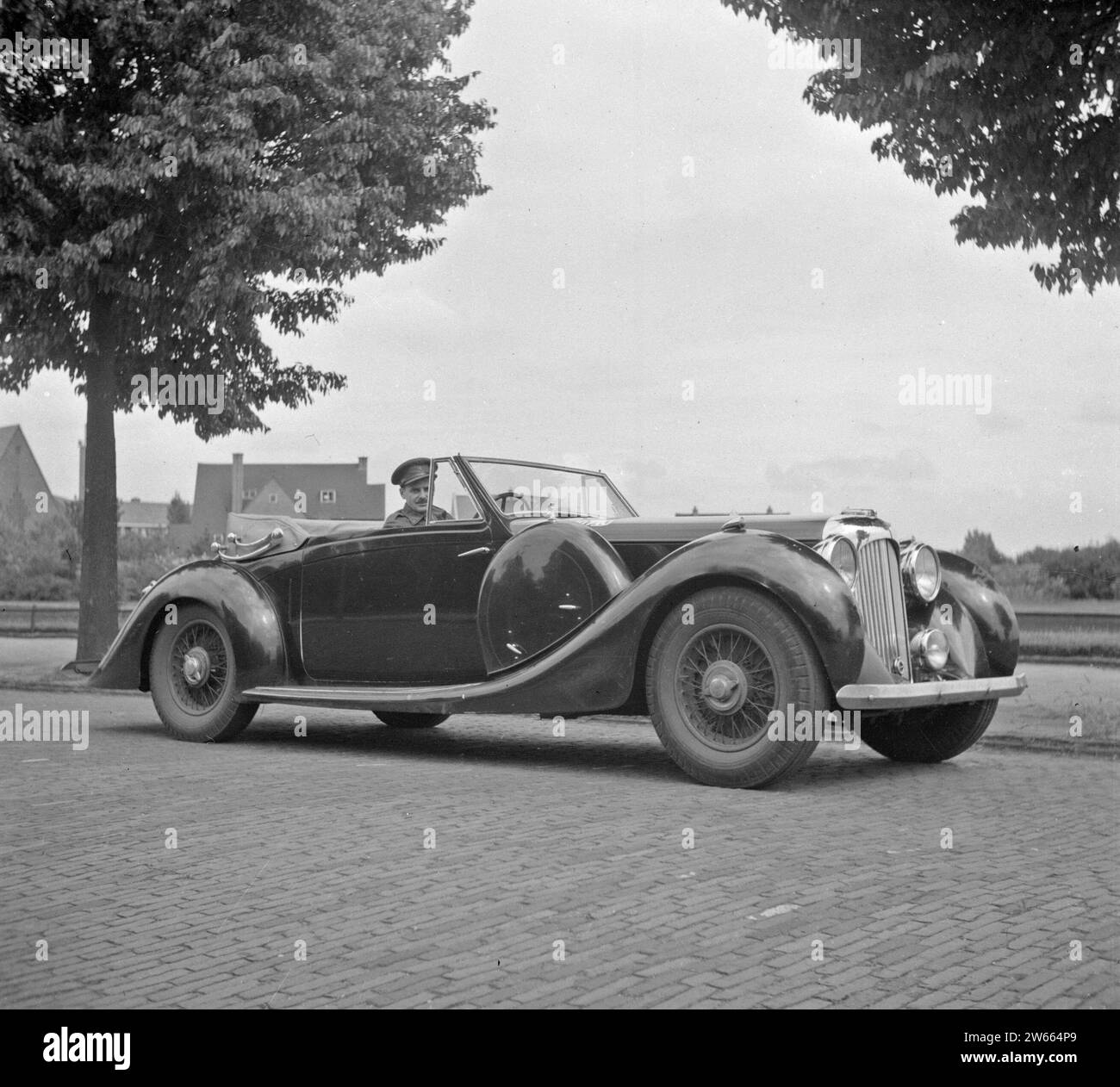 A soldier in a pre-war Riley Convertible somewhere in the Netherlands ...