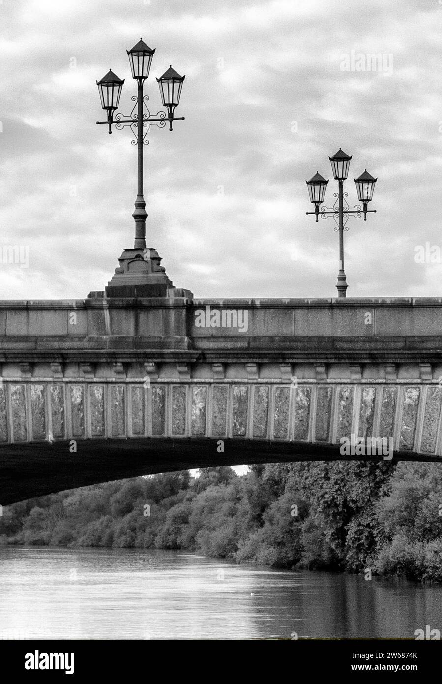 Classical three headed streetlights over Kew Bridge on the River Thames ...