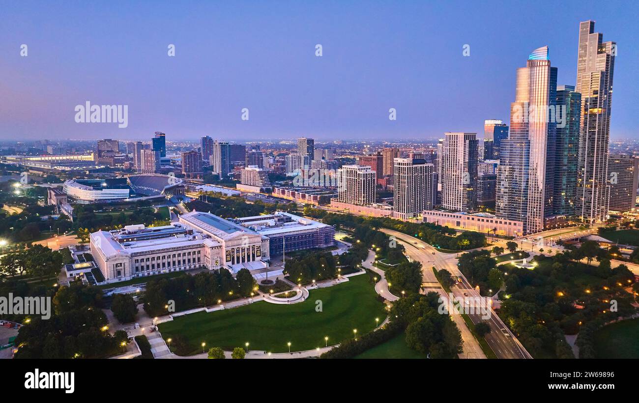 Field Museum aerial of Chicago city lights at night with sunset glow ...