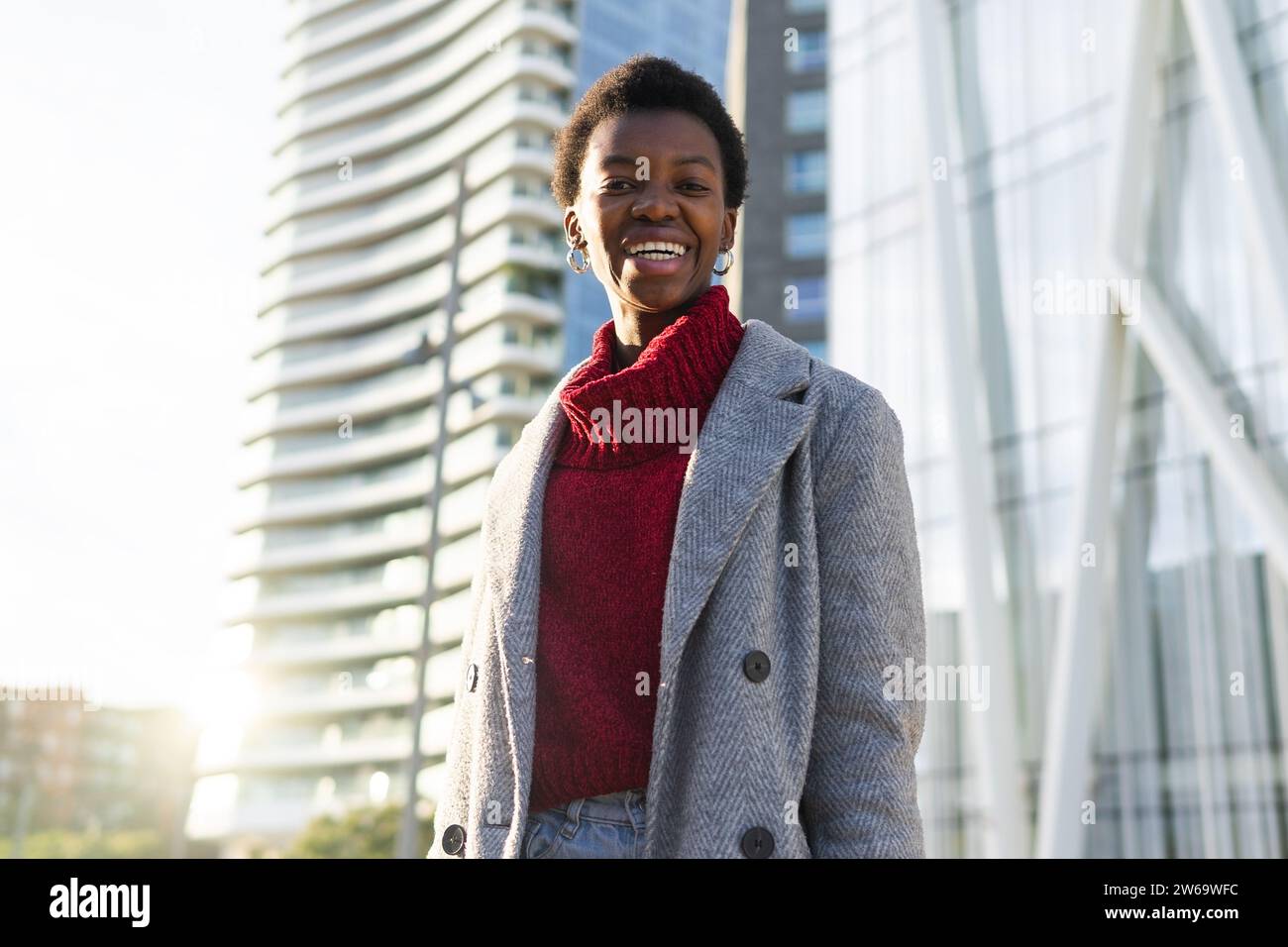 From below self assured smiling adult black female with short Afro ...
