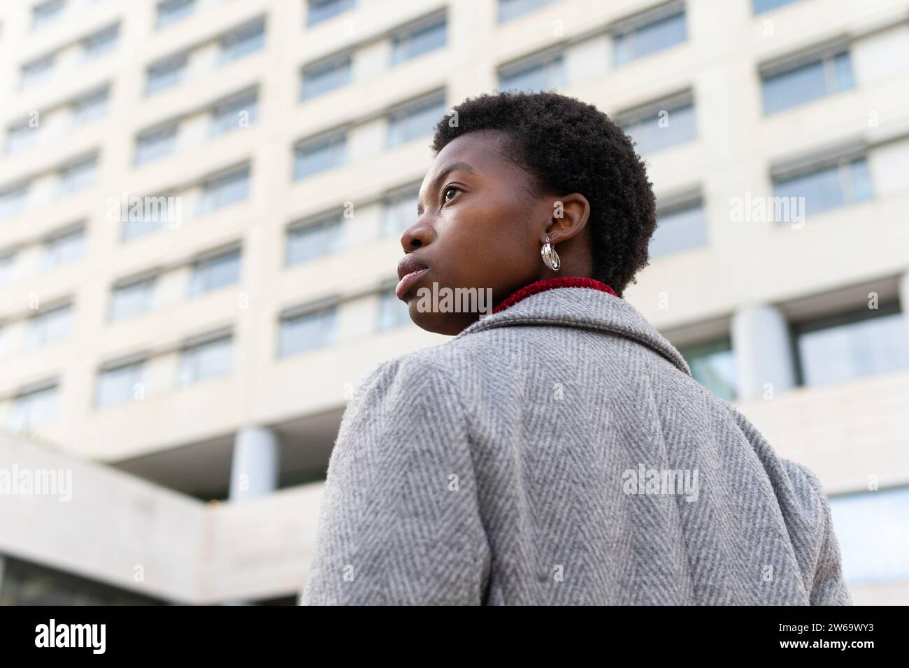 Low angle back view of young African American female standing against ...