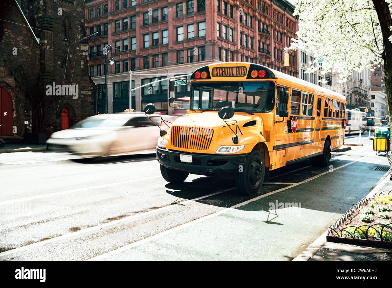 Bright yellow school bus on crossroad on busy street of Manhattan in ...