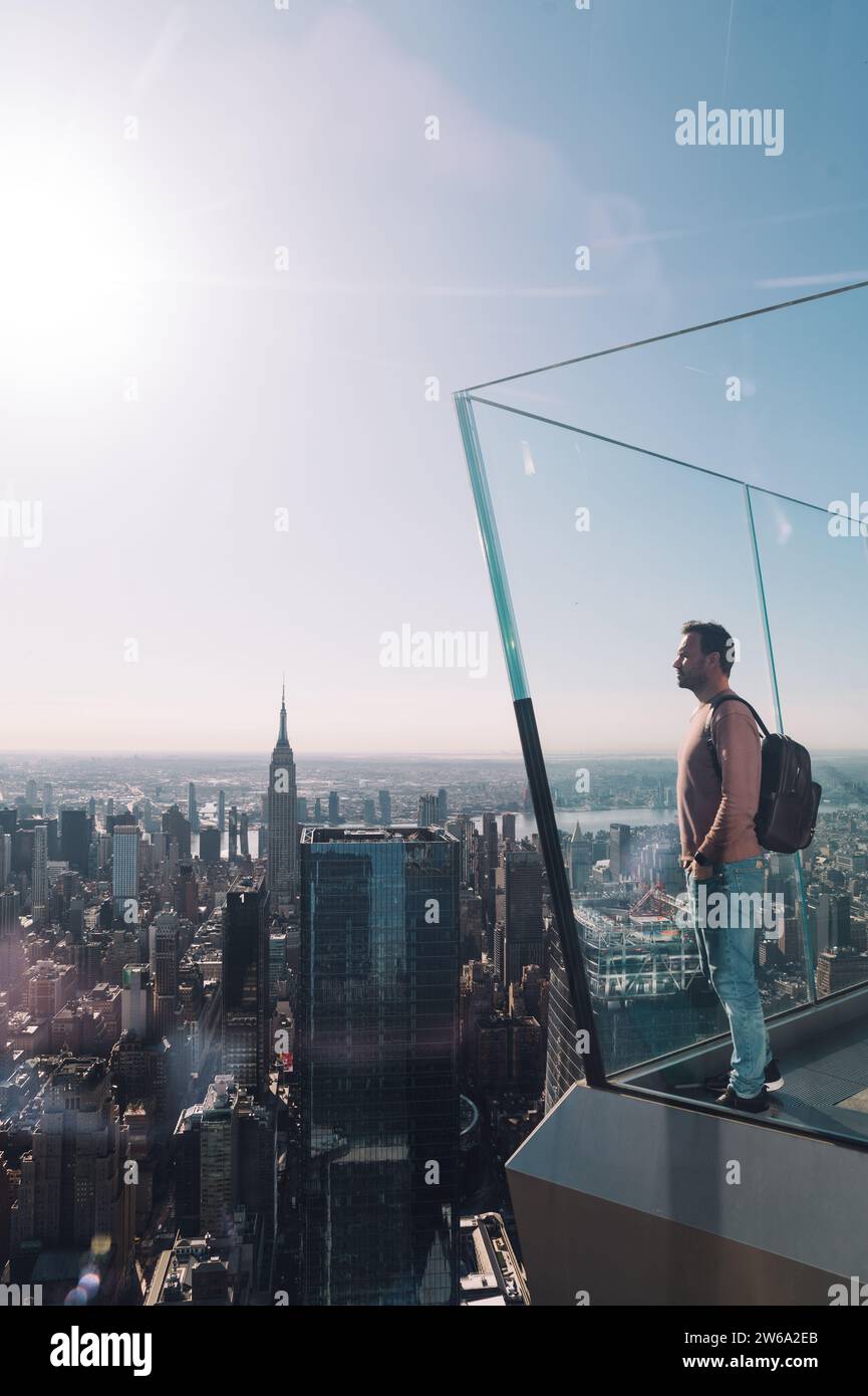 Man overlooking the expansive skyline of Manhattan, New York from a ...