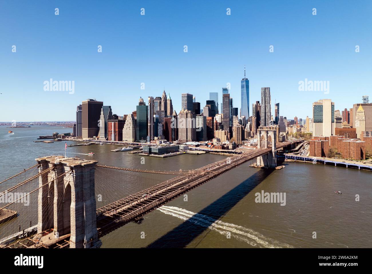 Elevated shot of the historic Brooklyn Bridge with the bustling New ...