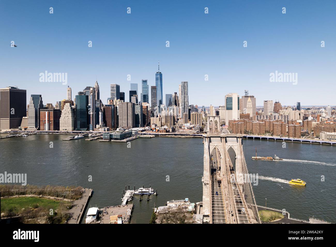 Aerial view of the Brooklyn Bridge stretching over the East River with Manhattan's cityscape in ...