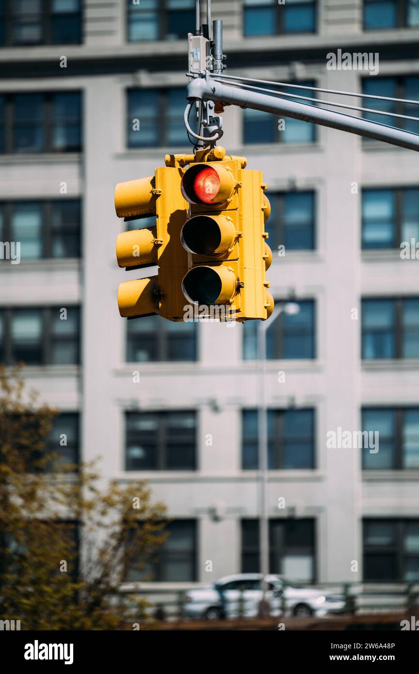 A vibrant yellow traffic light stands prominently against a backdrop of ...