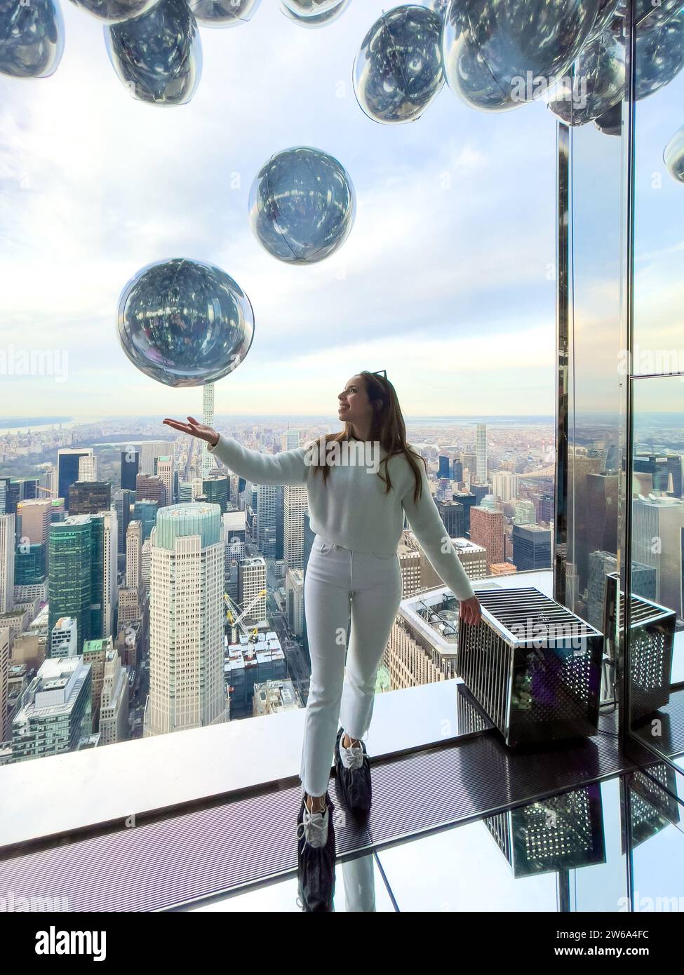 Full length of young happy female traveler interacting with silver ...