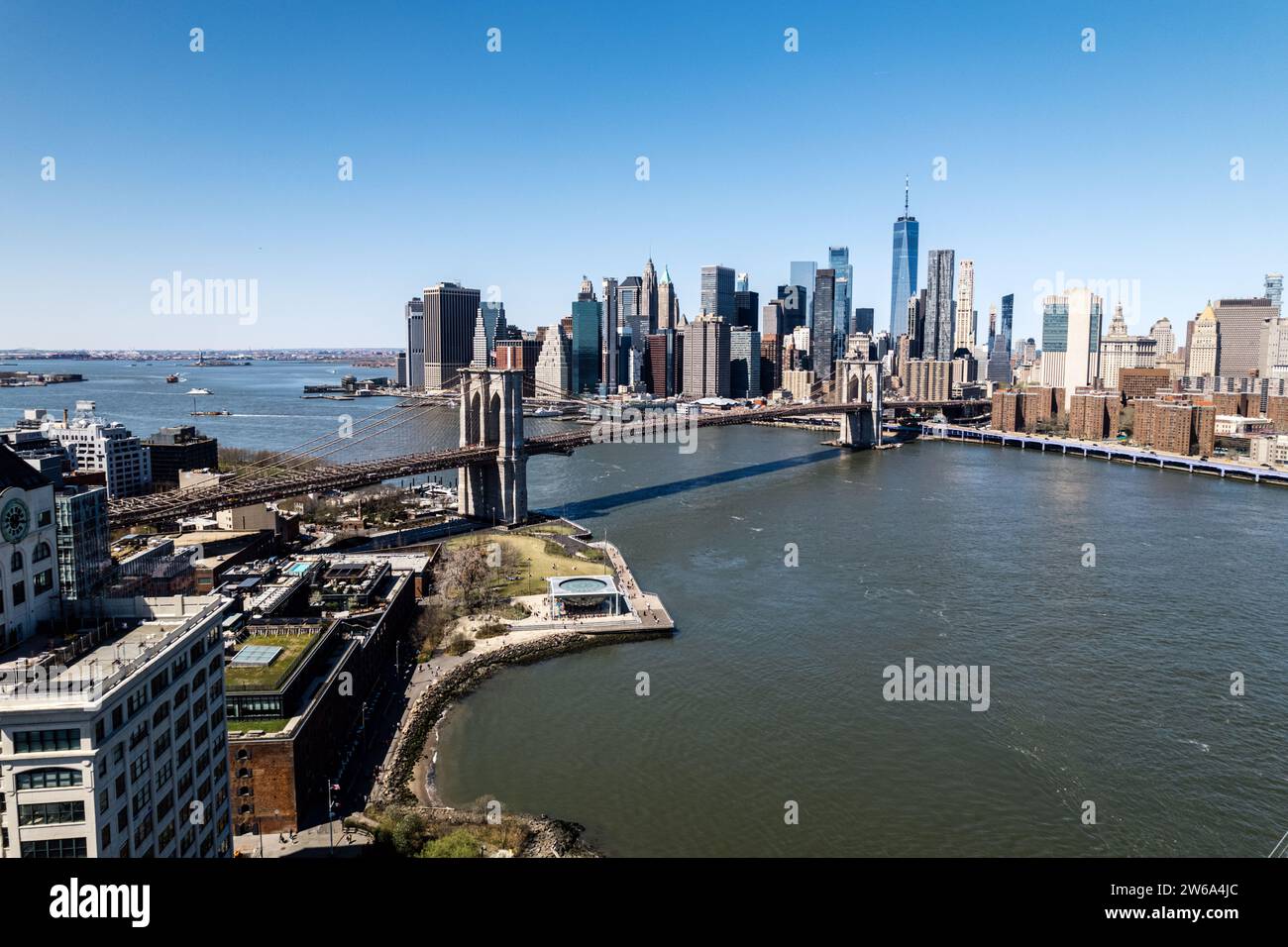 Elevated shot of the historic Brooklyn Bridge with the bustling New ...