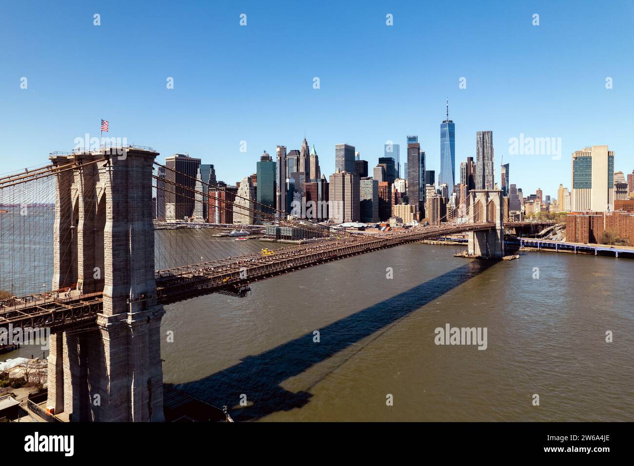 Elevated shot of the historic Brooklyn Bridge with the bustling New ...
