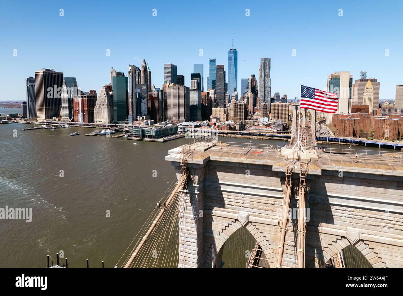 Elevated shot of the historic Brooklyn Bridge with the bustling New ...